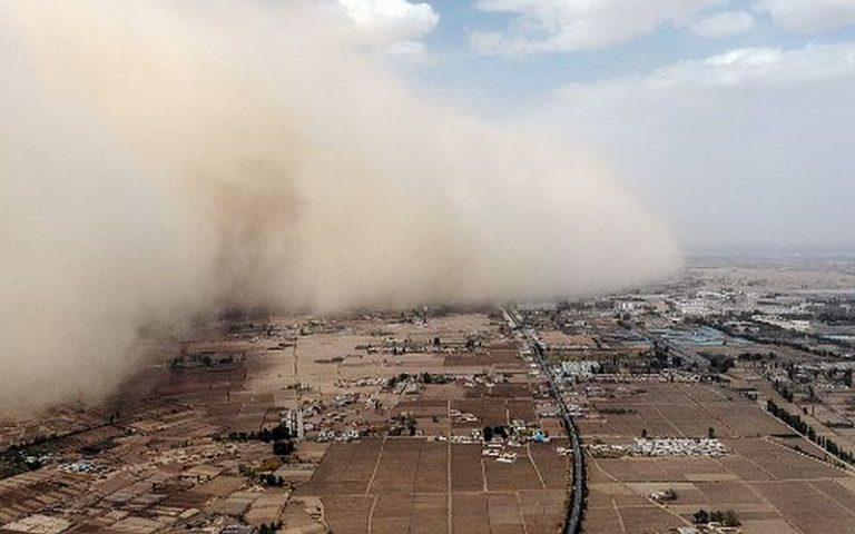Wall of sand engulfs towns as dust storms barrel across China | Free ...